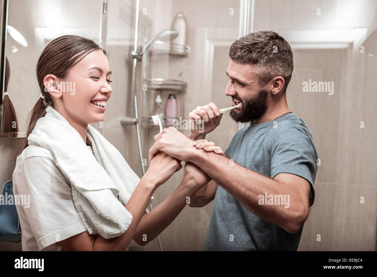 Young loving couple having much fun while brushing teeth together Stock ...