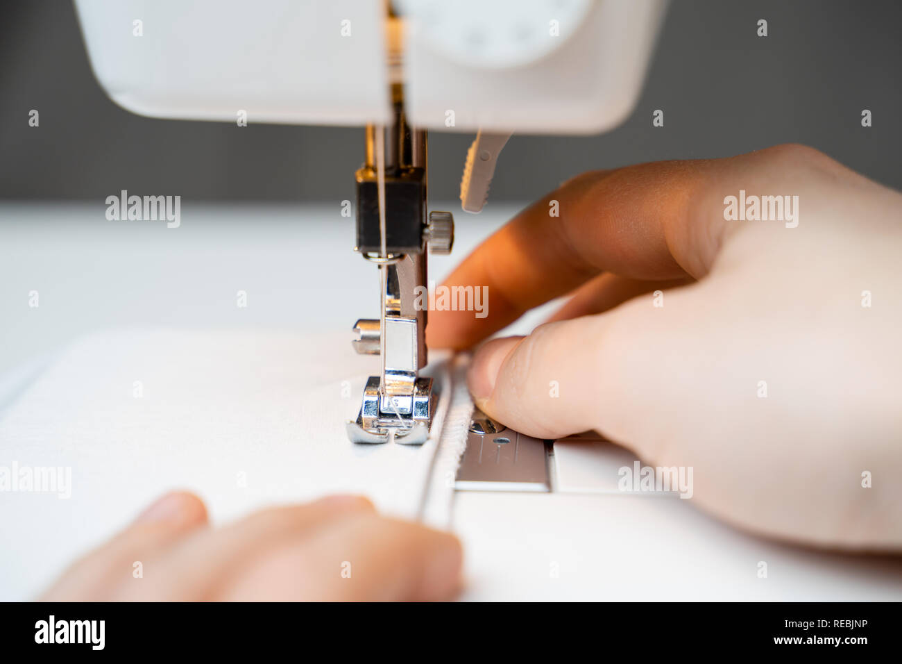 Closeup the sewing machine and item of clothing Stock Photo - Alamy