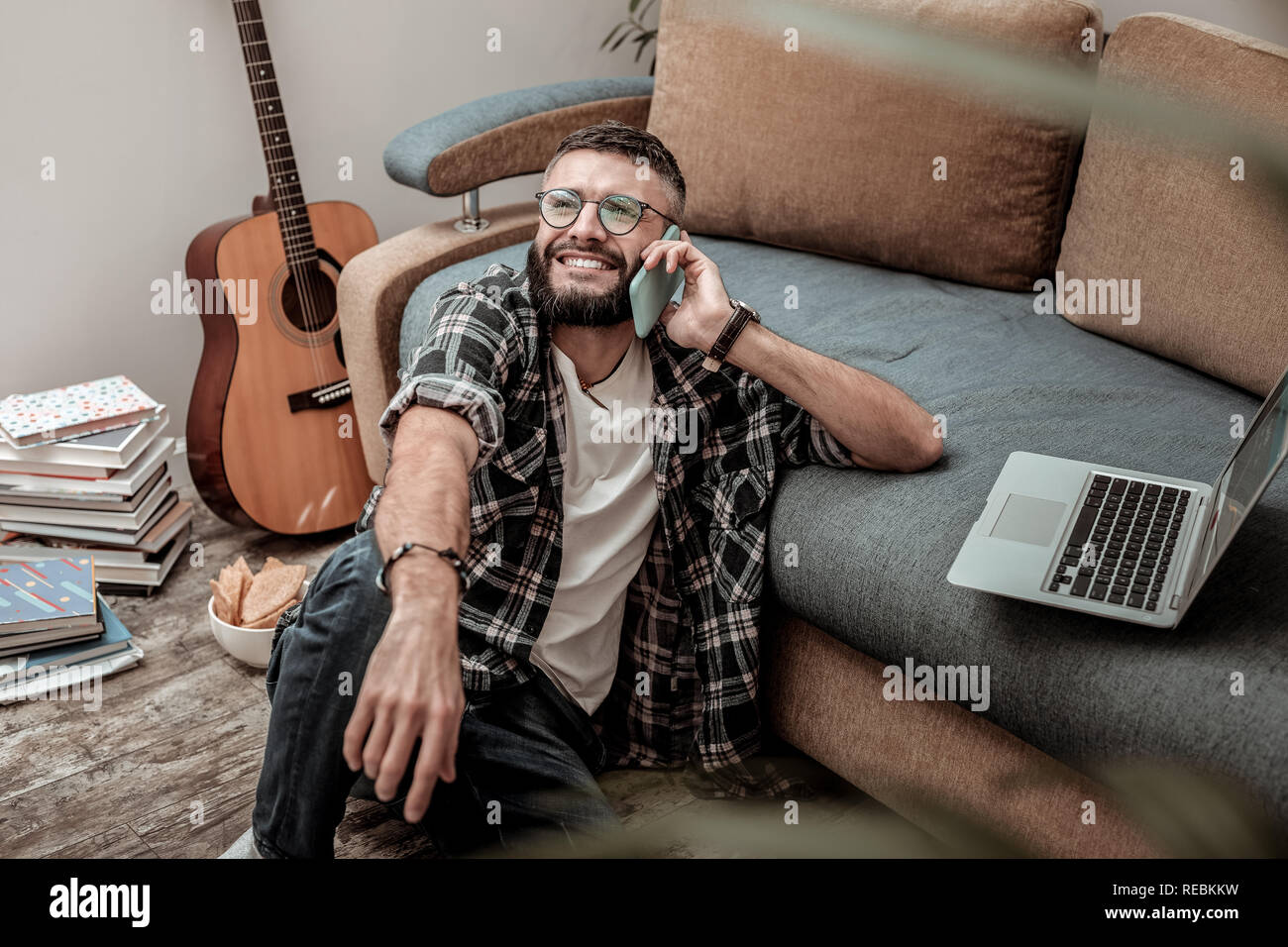 Positive joyful man answering the phone call Stock Photo - Alamy