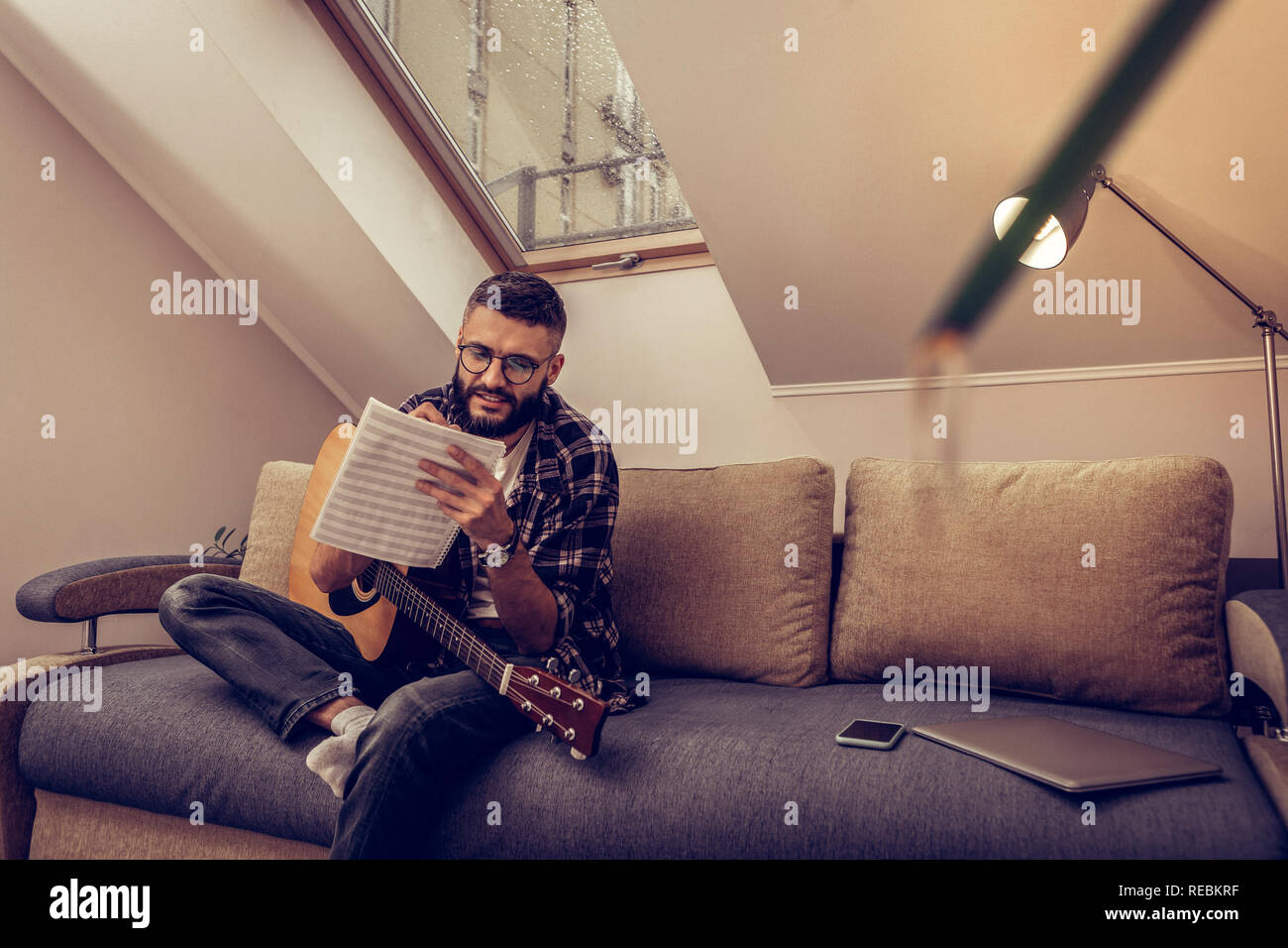 Delighted positive man holding his note charts Stock Photo - Alamy