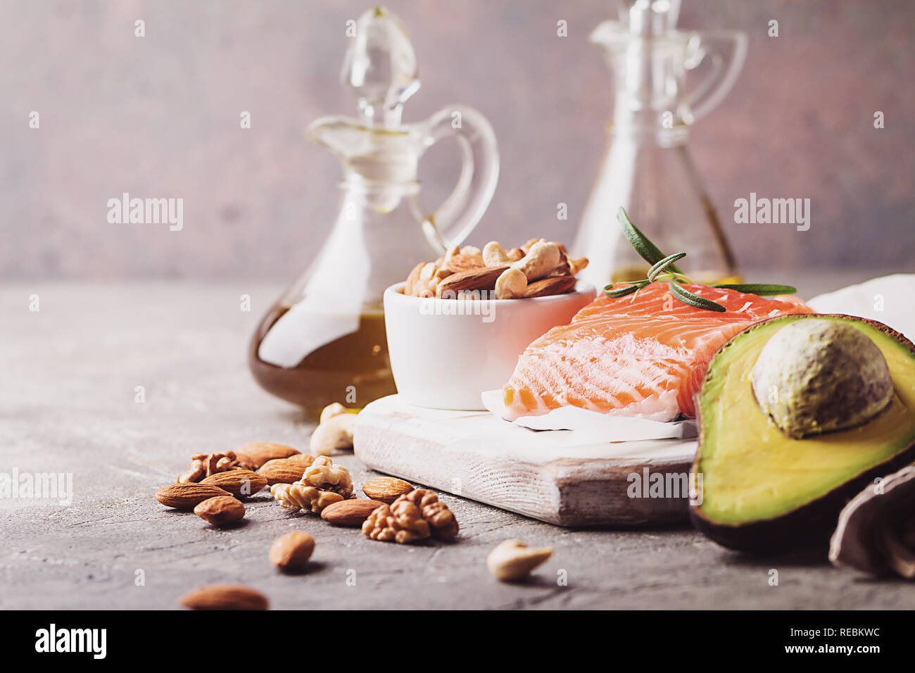 Healthy fats in nutrition - salmon, avocado, oil, nuts. Concept of ...