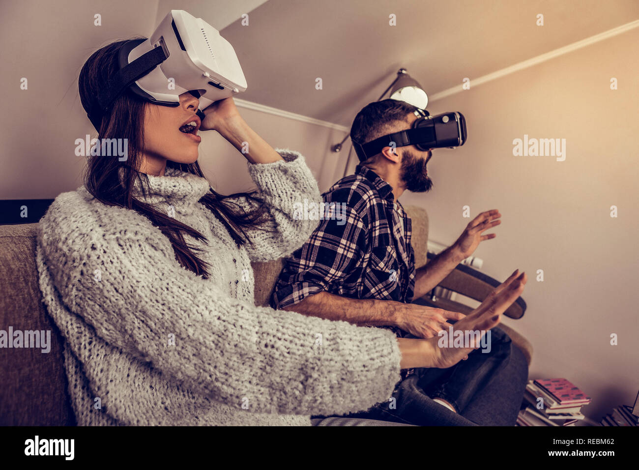 Positive emotional young couple trying new technologies Stock Photo - Alamy