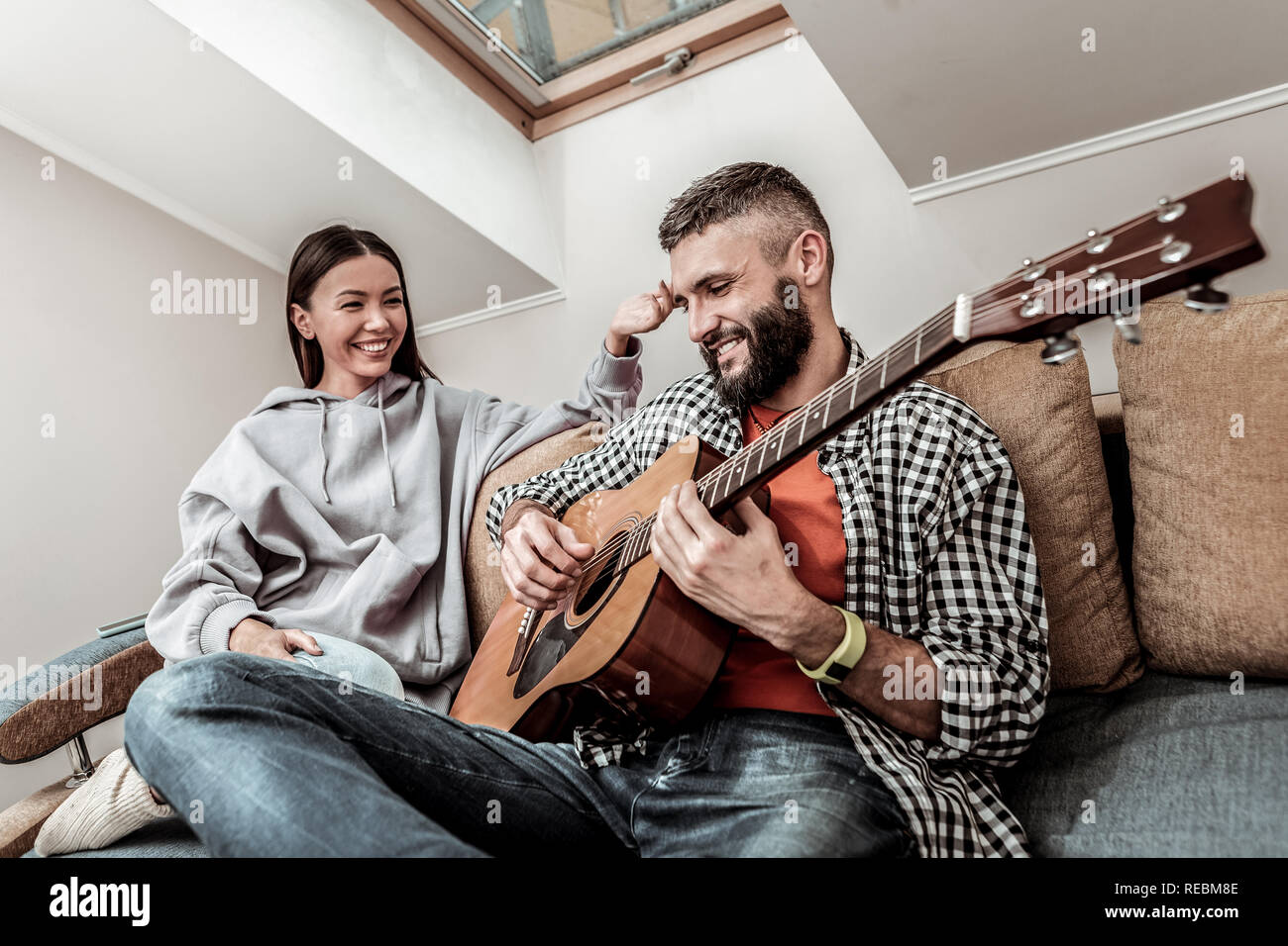 Positive young couple relaxing at home together Stock Photo - Alamy