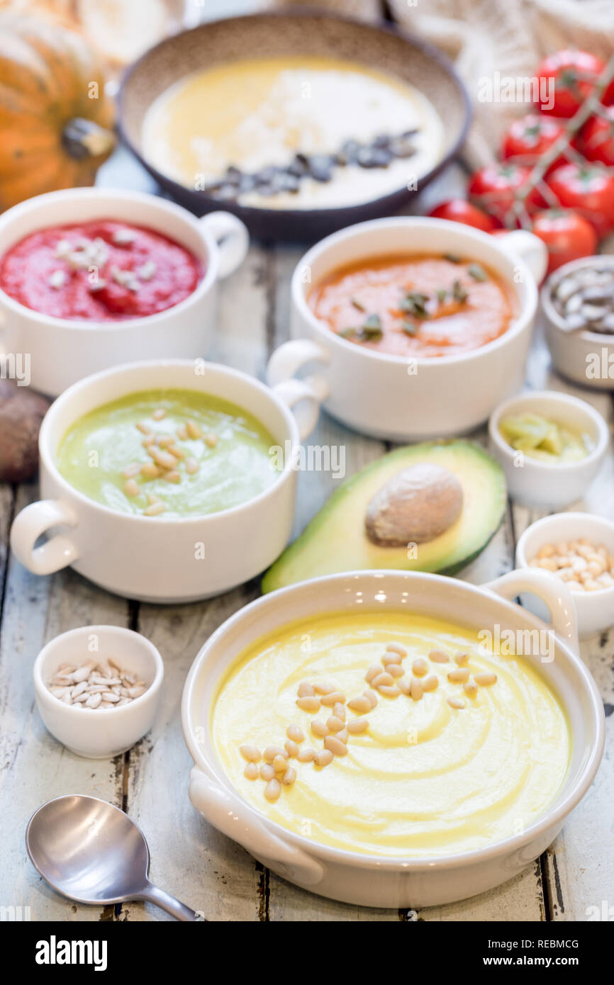 Variety of different colorful vegetable cream soups in a bowls. Concept ...