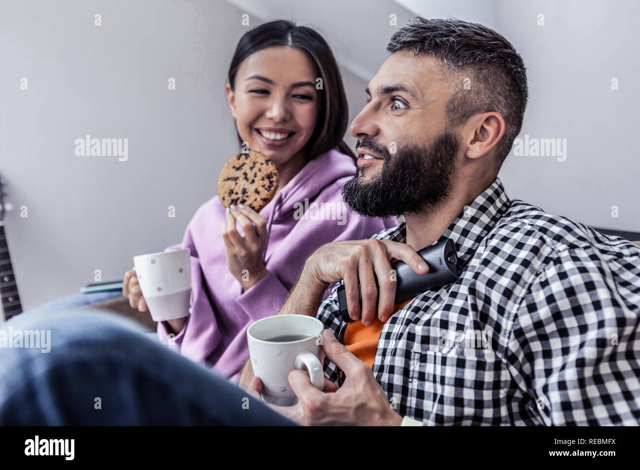 Nice excited man watching an action movie Stock Photo - Alamy