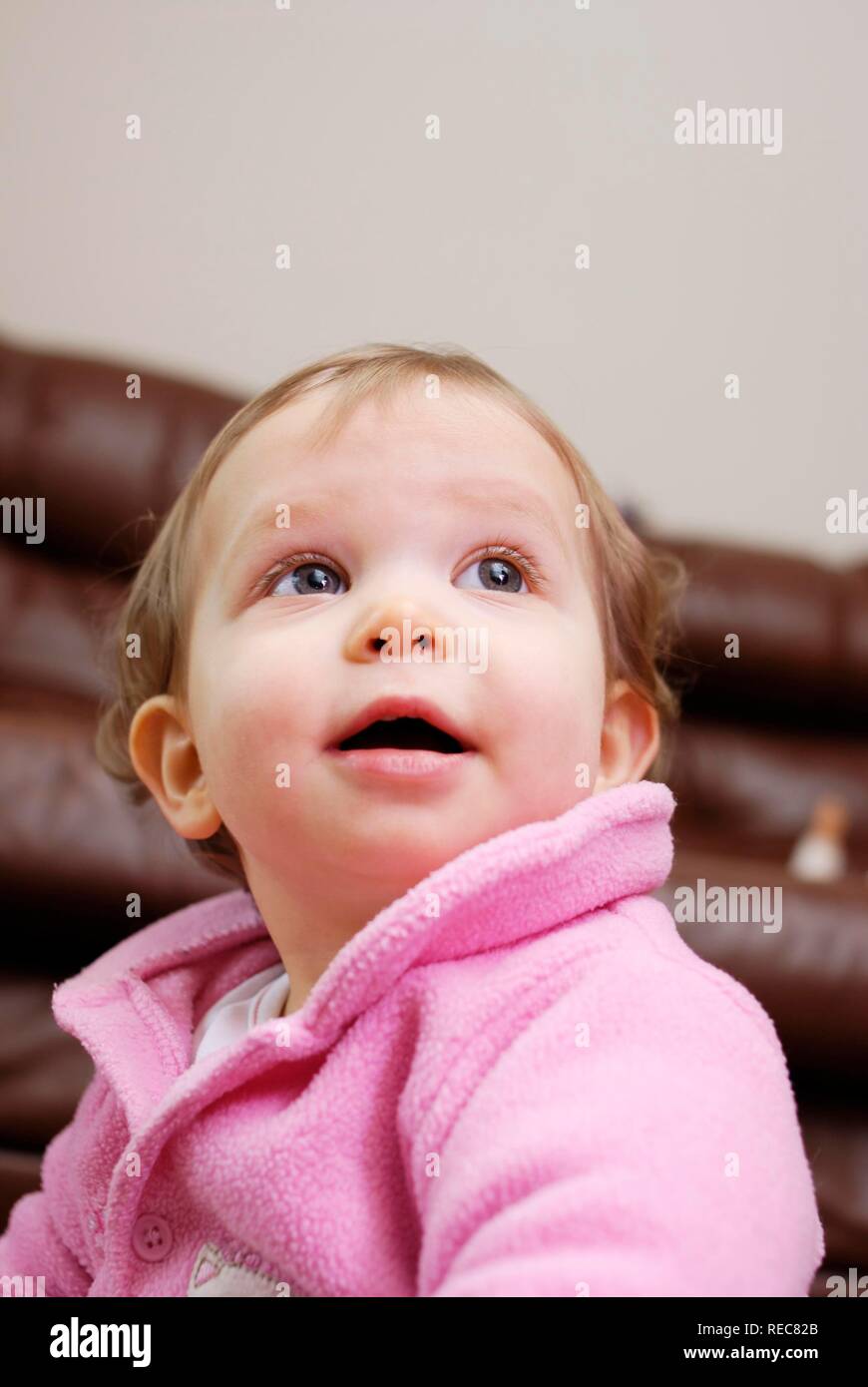 Portrait of baby girl looking up Stock Photo - Alamy