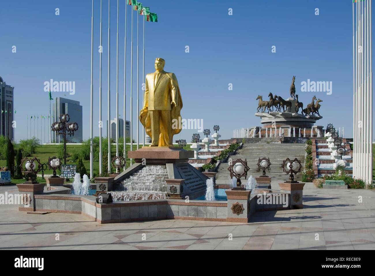 Gold covered statue of President Turkmenbasy in front of the monument ...