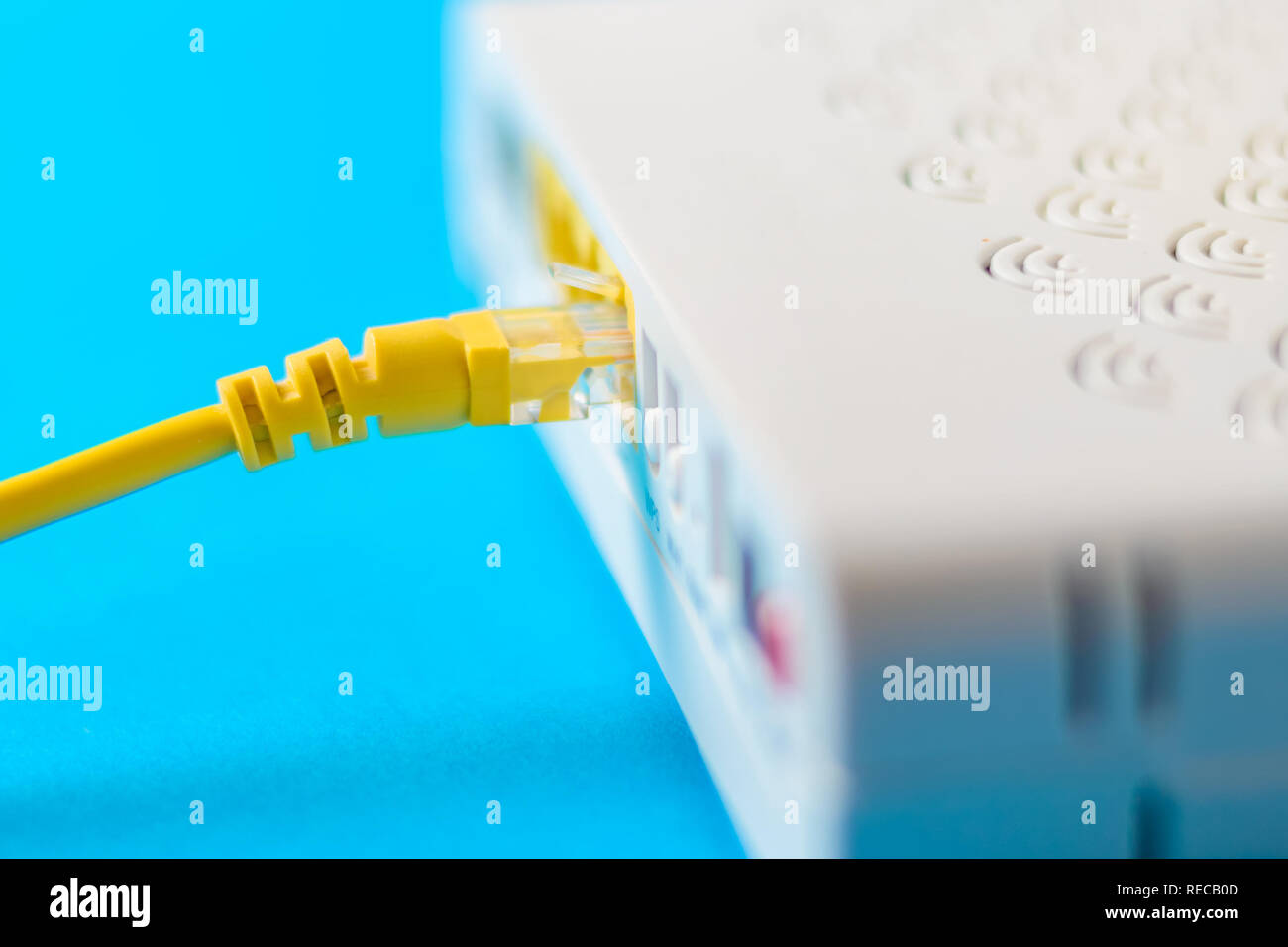 internet modem router hub with cable connecting on blue background ...