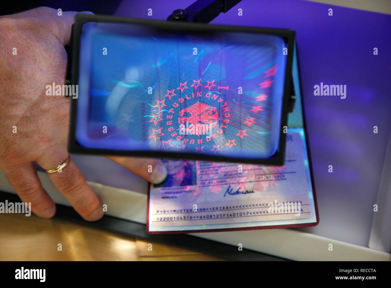 Police inspection, validating documents, passport, using UV light and a ...
