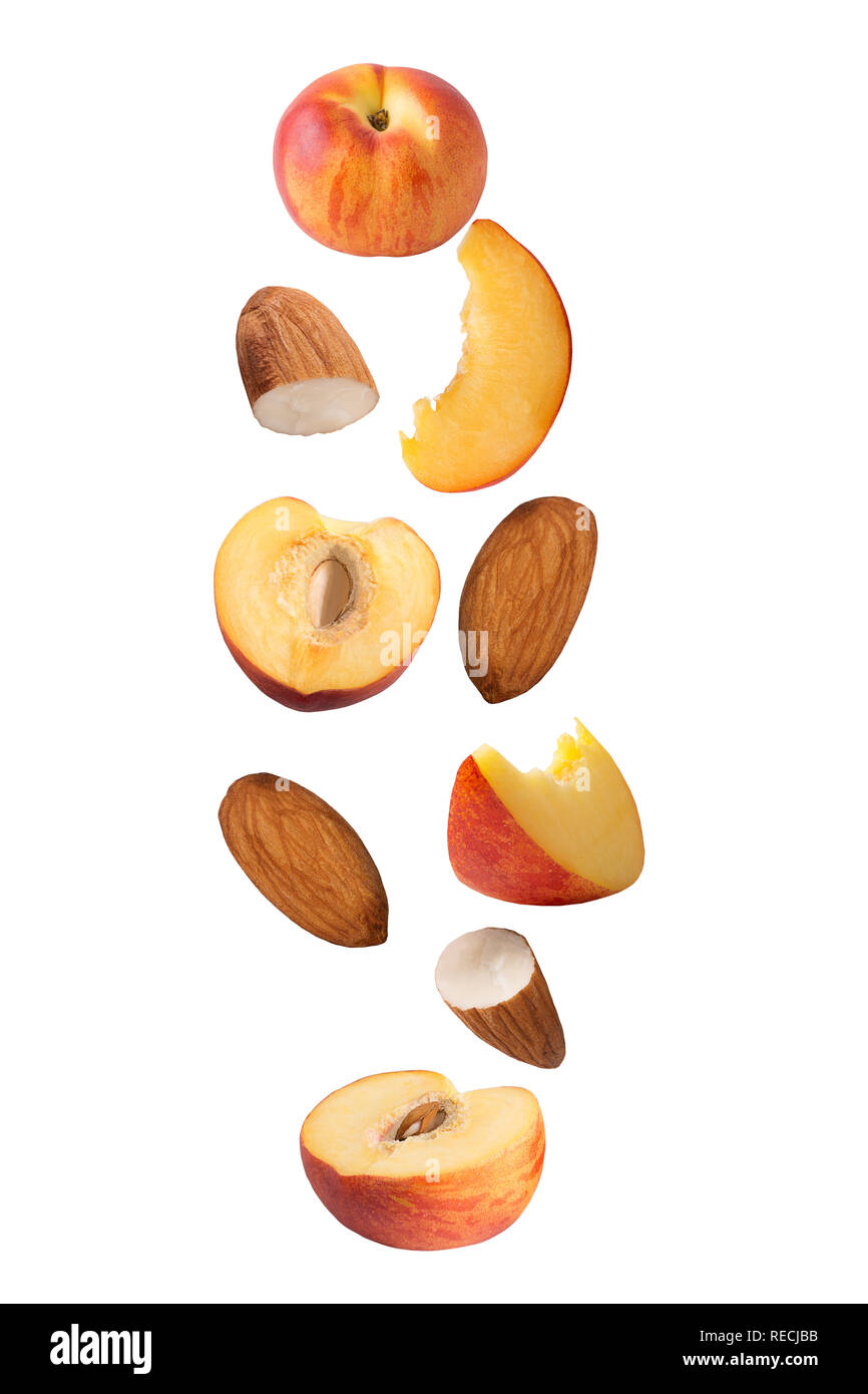 Flying fruits. Falling peach and almonds isolated on white background ...