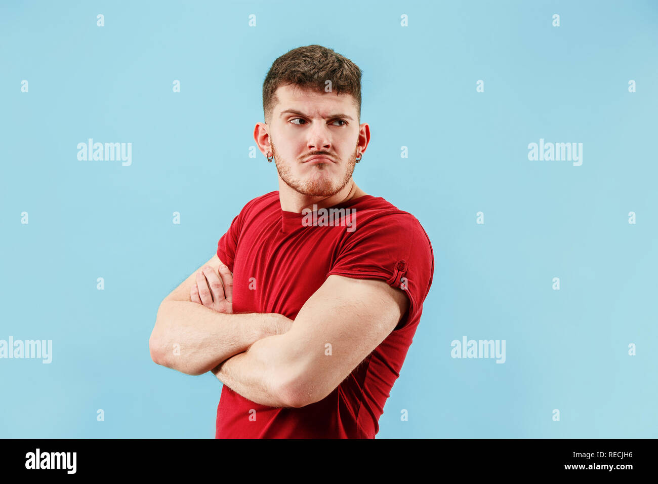 The sad emotional angry man screaming on blue studio background ...