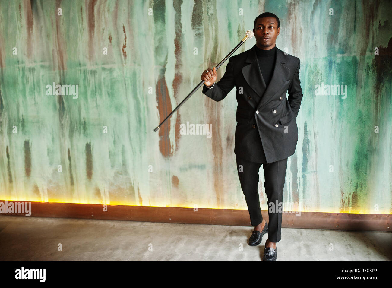 Stylish african american gentleman in elegant black jacket, holding ...