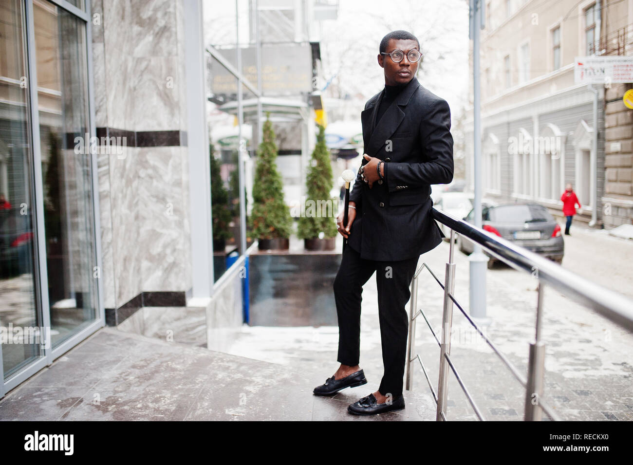 Stylish african american gentleman in elegant black jacket, holding ...