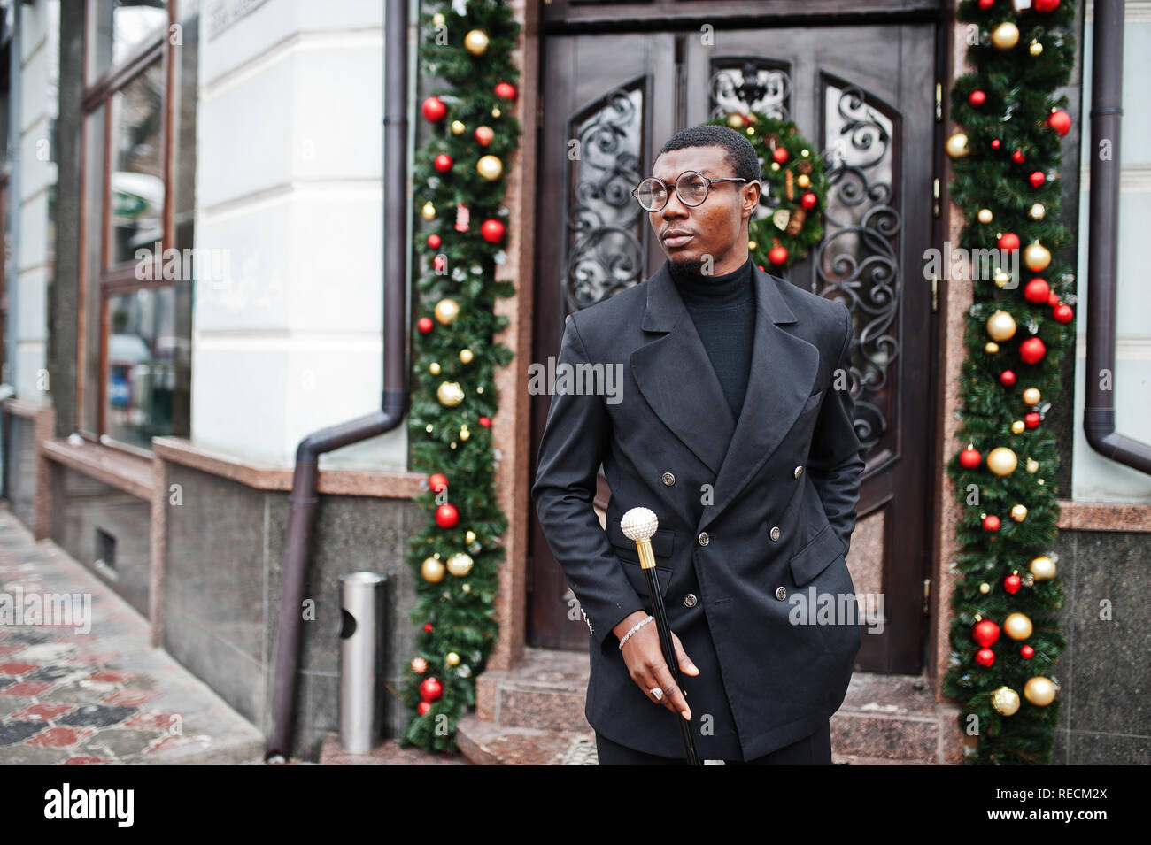 Stylish african american gentleman in elegant black jacket, holding ...