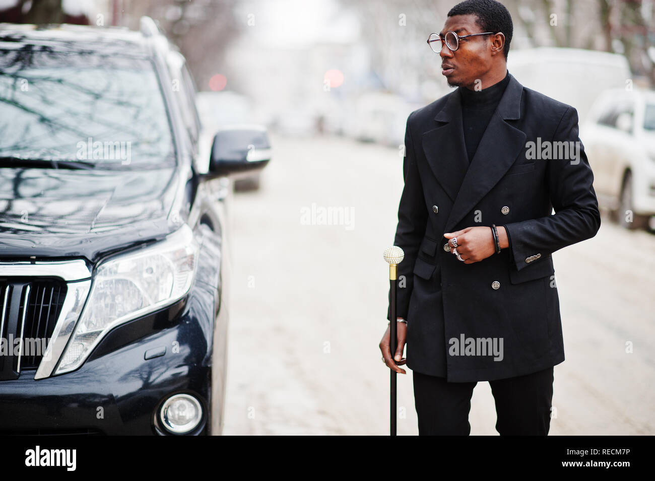 Stylish african american gentleman in elegant black jacket, holding ...