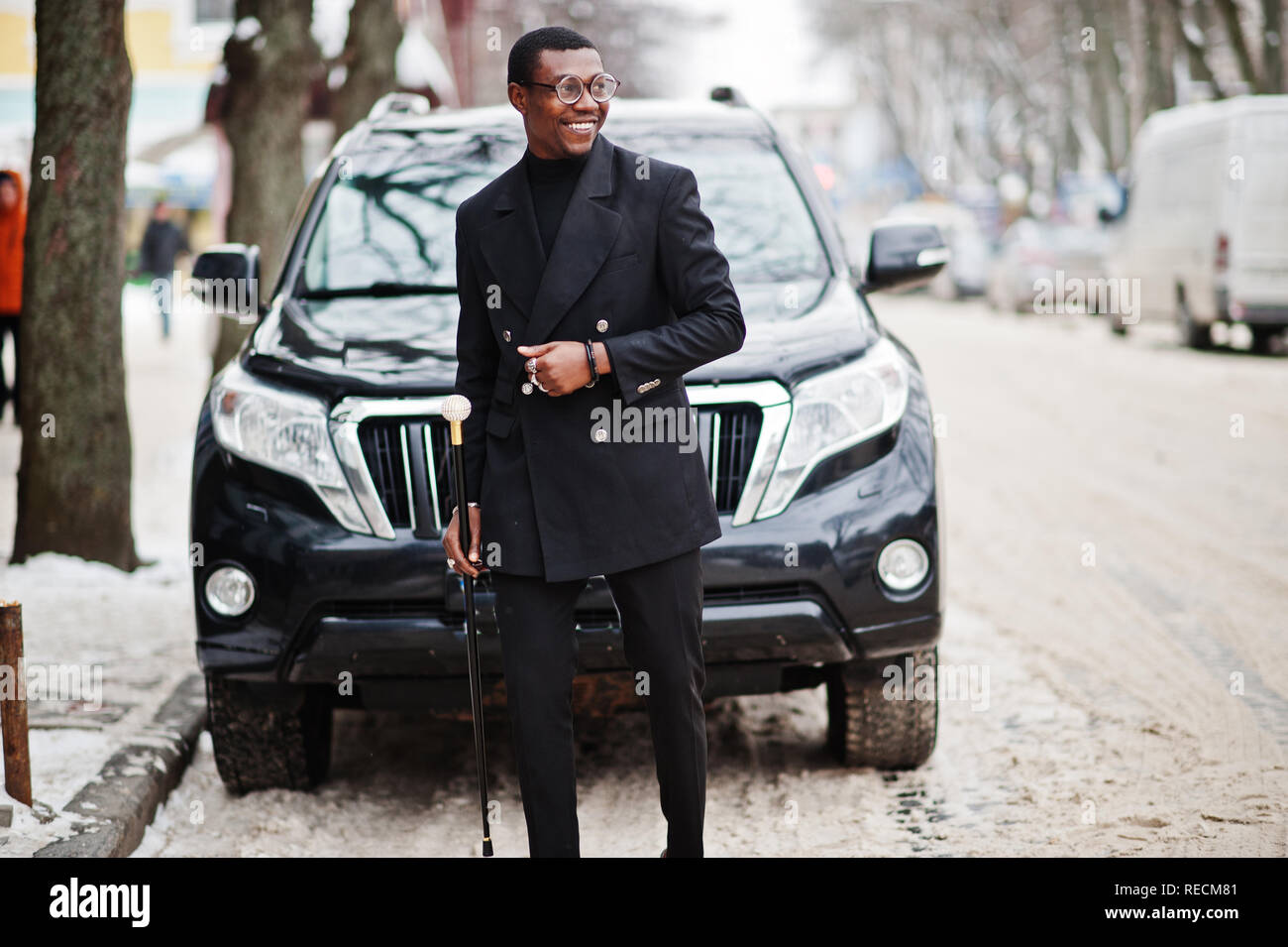 Stylish african american gentleman in elegant black jacket, holding ...