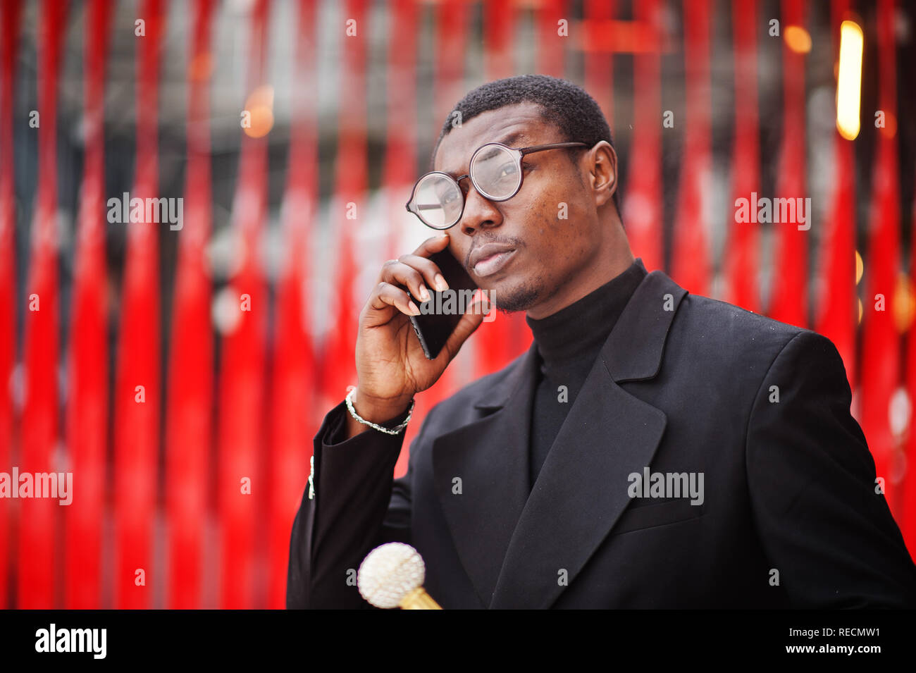 Stylish african american gentleman in elegant black jacket, holding ...