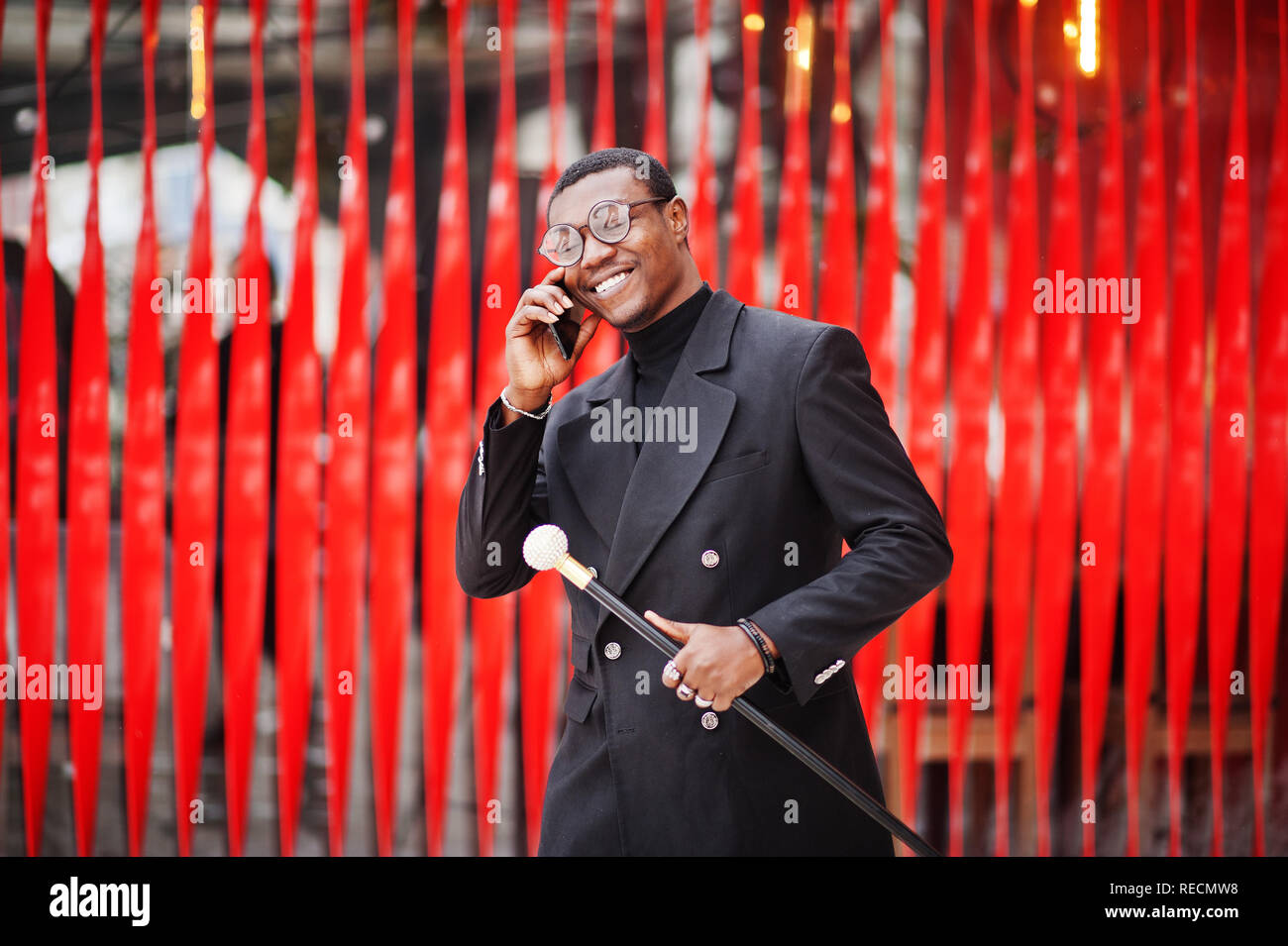 Stylish african american gentleman in elegant black jacket, holding ...
