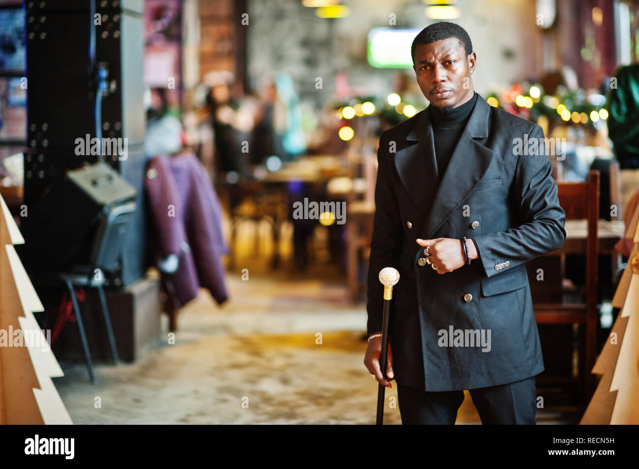 Stylish african american gentleman in elegant black jacket, holding ...