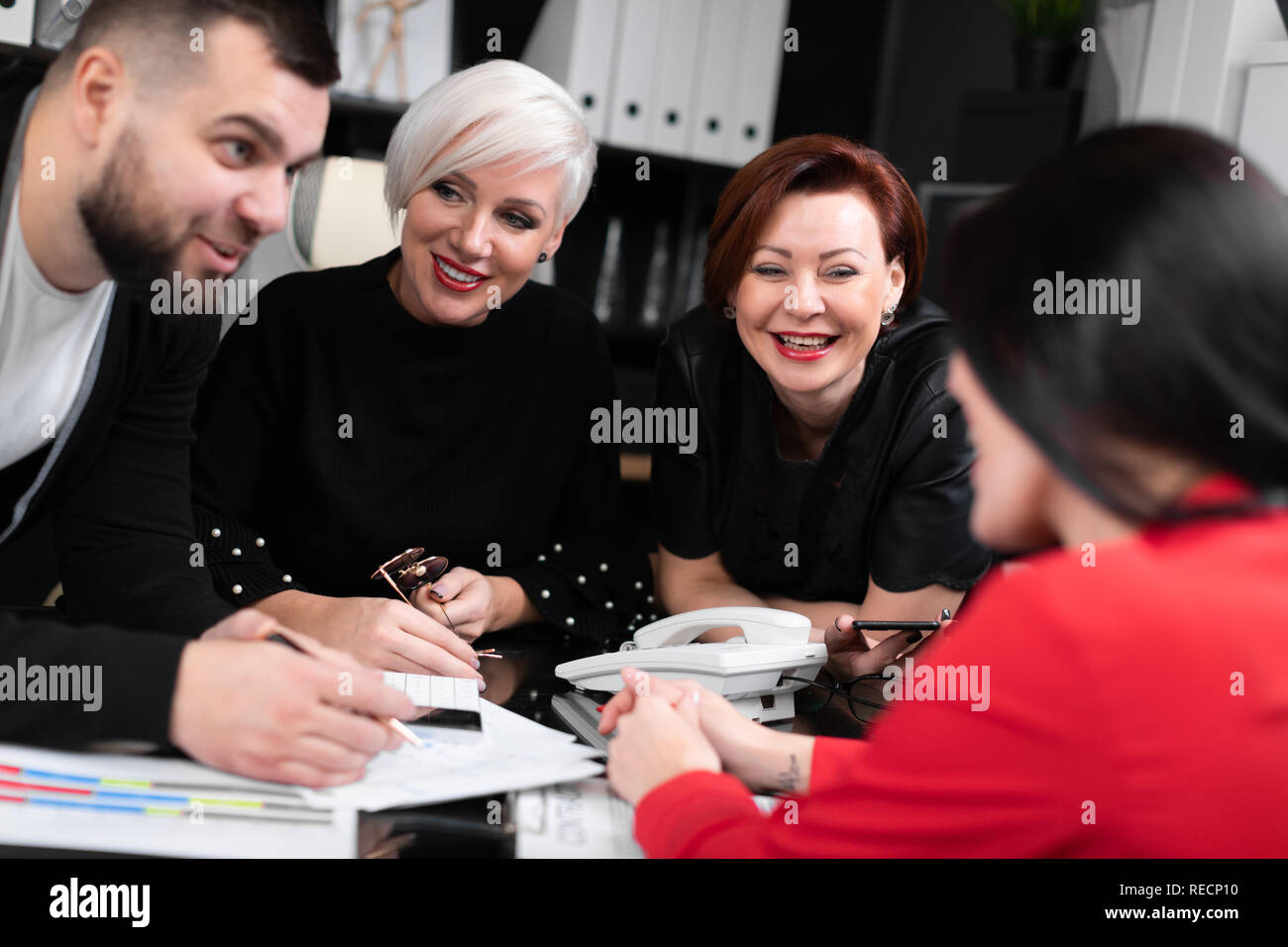 Smiling employees talking in workplace Stock Photo - Alamy