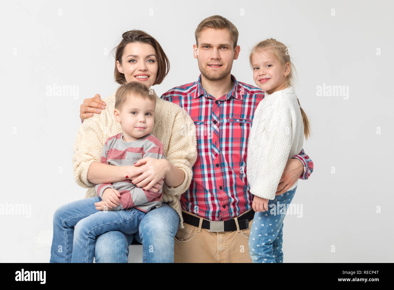 Cheerful family of four on white background Stock Photo - Alamy