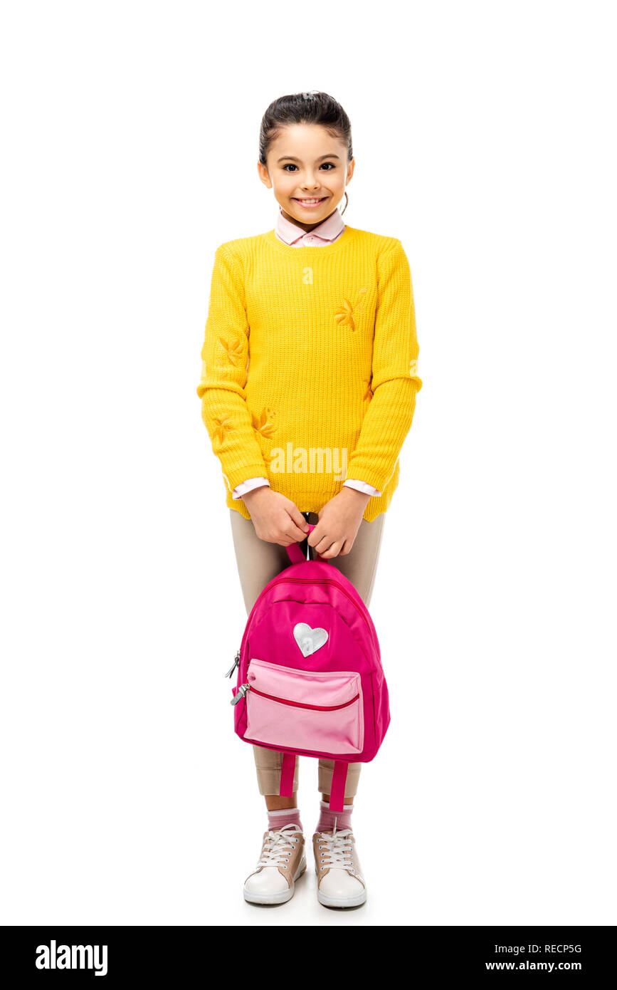 adorable child holding backpack and smiling at camera isolated on white ...