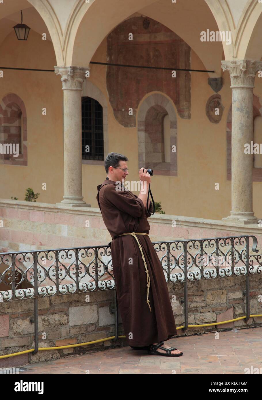 Photographing monk in the cloister of the monastery of San Francesco in ...