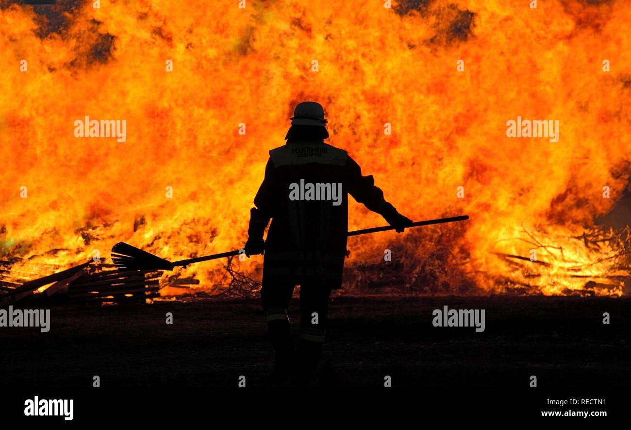 Fireman in front of fire Stock Photo - Alamy