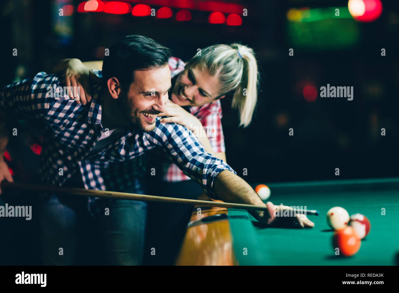 Young couple playing snooker together in bar Stock Photo - Alamy
