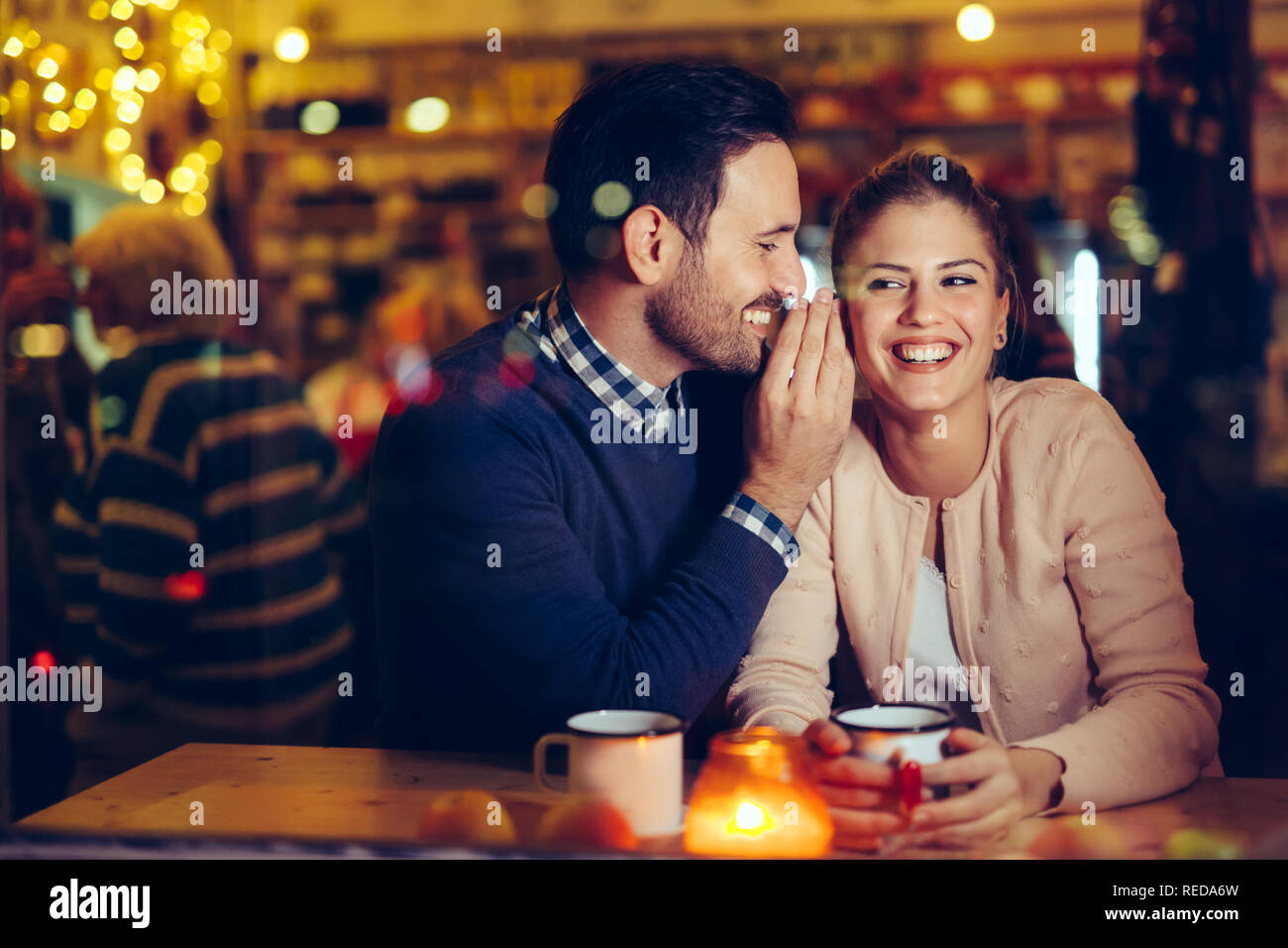Romantic couple dating in pub at night Stock Photo - Alamy