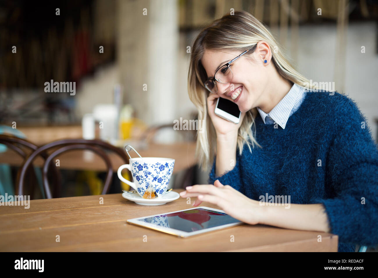 Portrait of busy businesswoman in coffee shop Stock Photo - Alamy