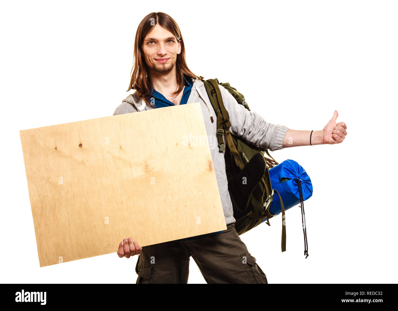 Man tourist backpacker holding blank wood plank copy space. Young guy ...