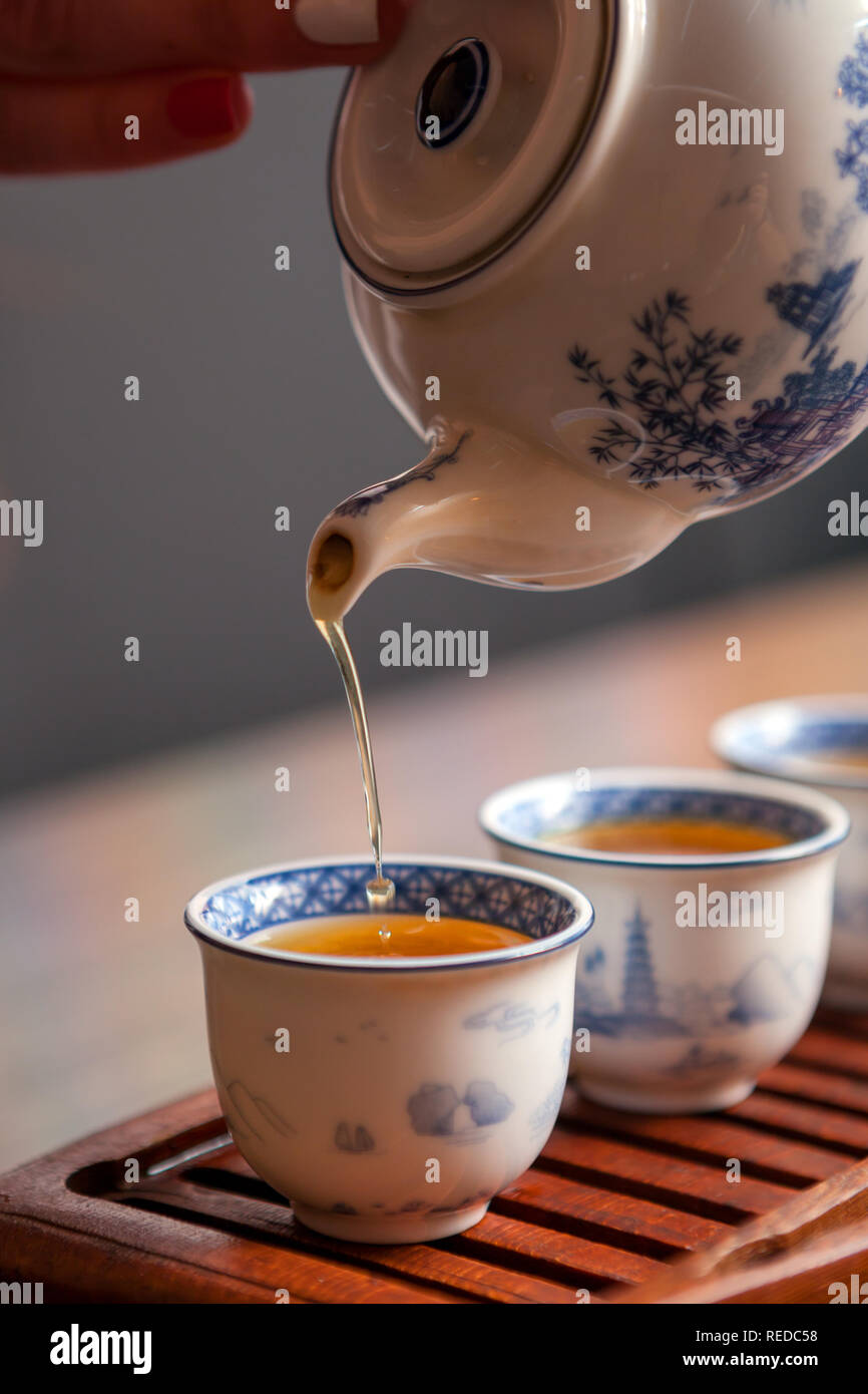 Woman pouring green tea cups hi-res stock photography and images - Alamy