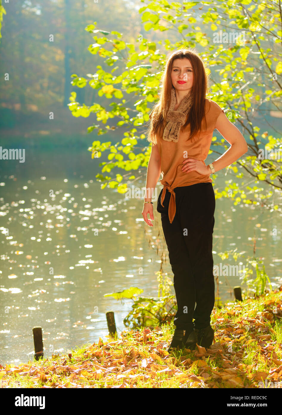 Woman walking through park in fall. Autumnal nature fashion relax ...