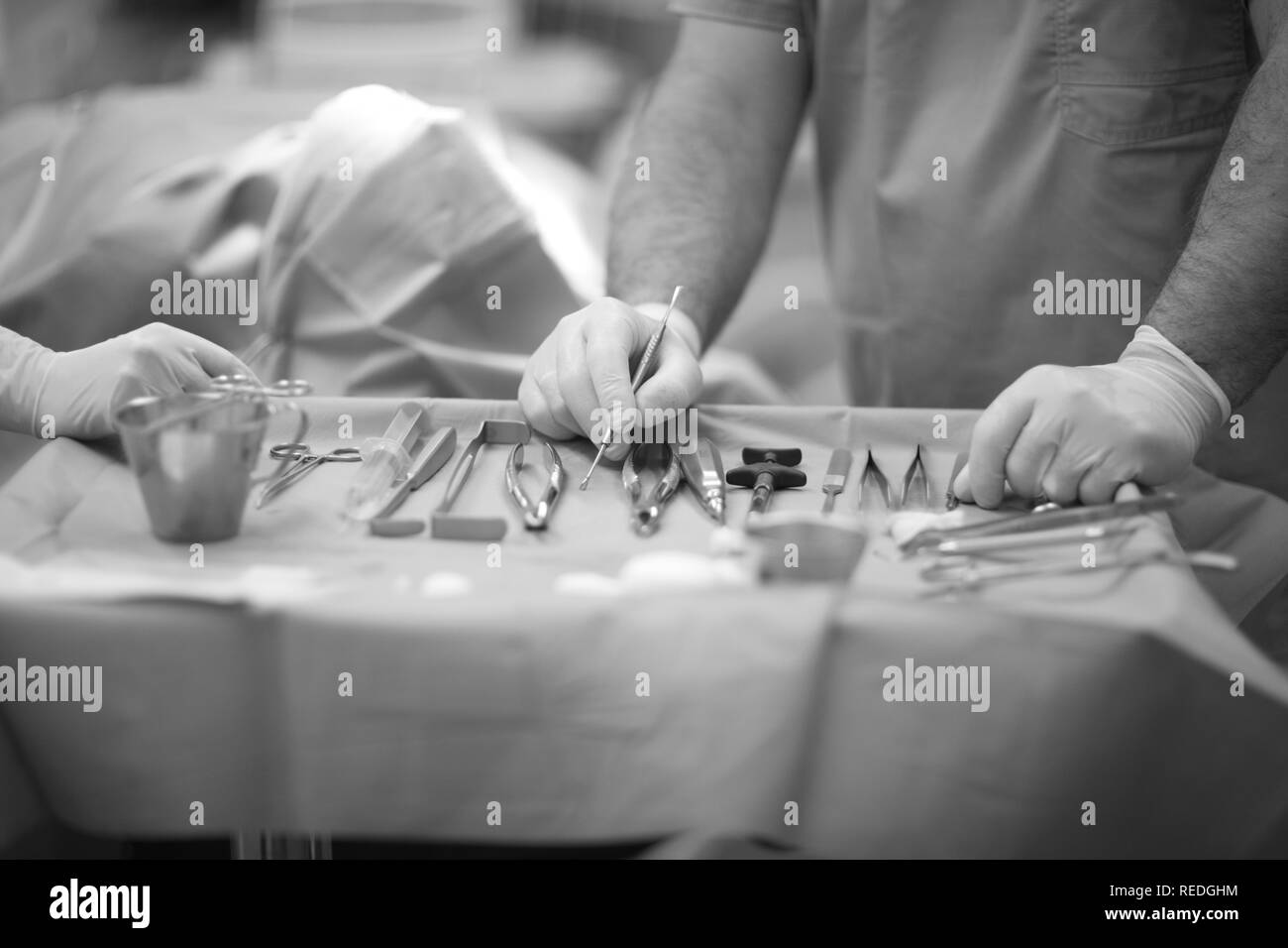 Doctor's hands on the table with the tool in the operating room dental ...