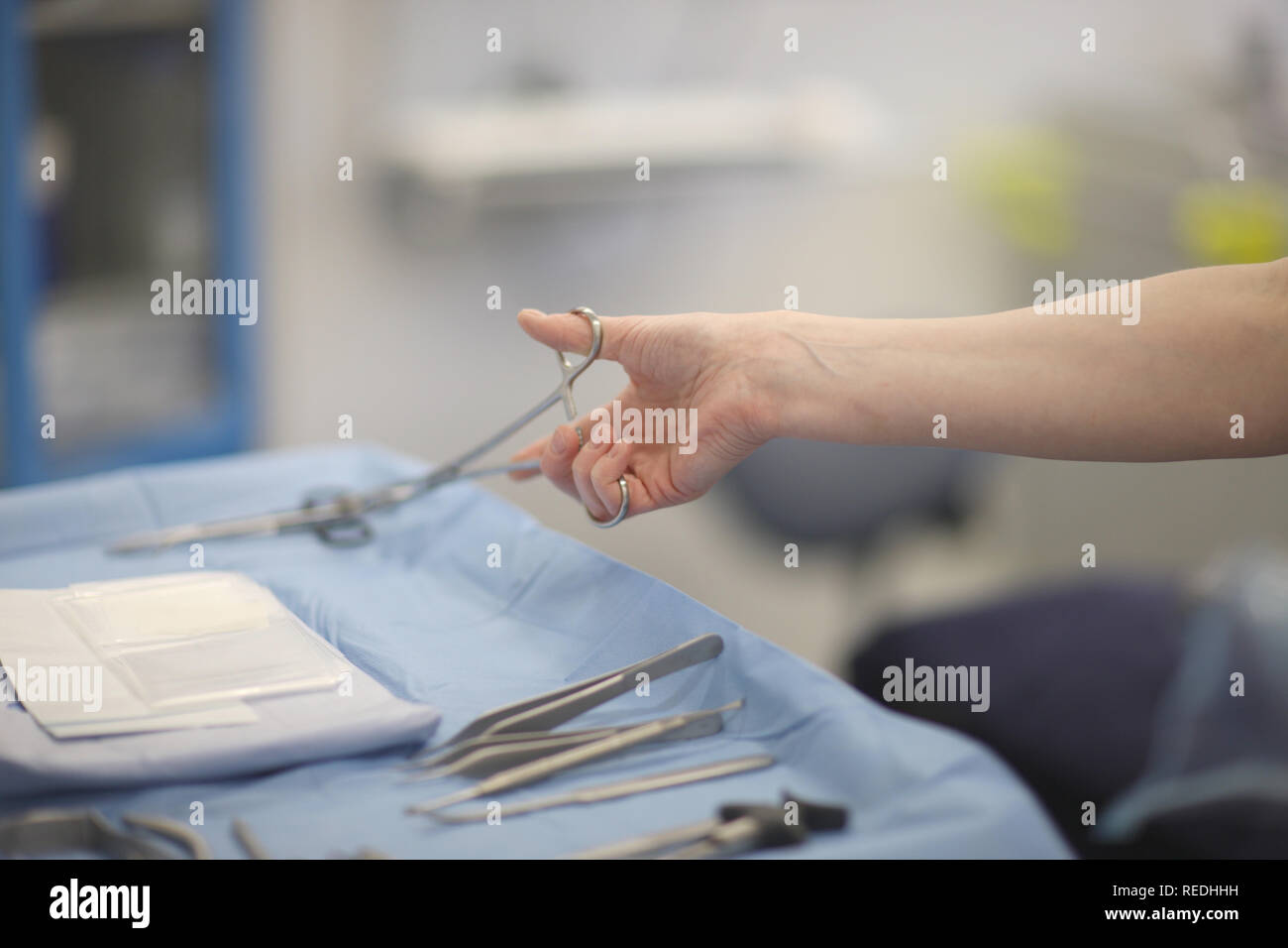 The hand of a dental assistant with a tool after medical procedures ...