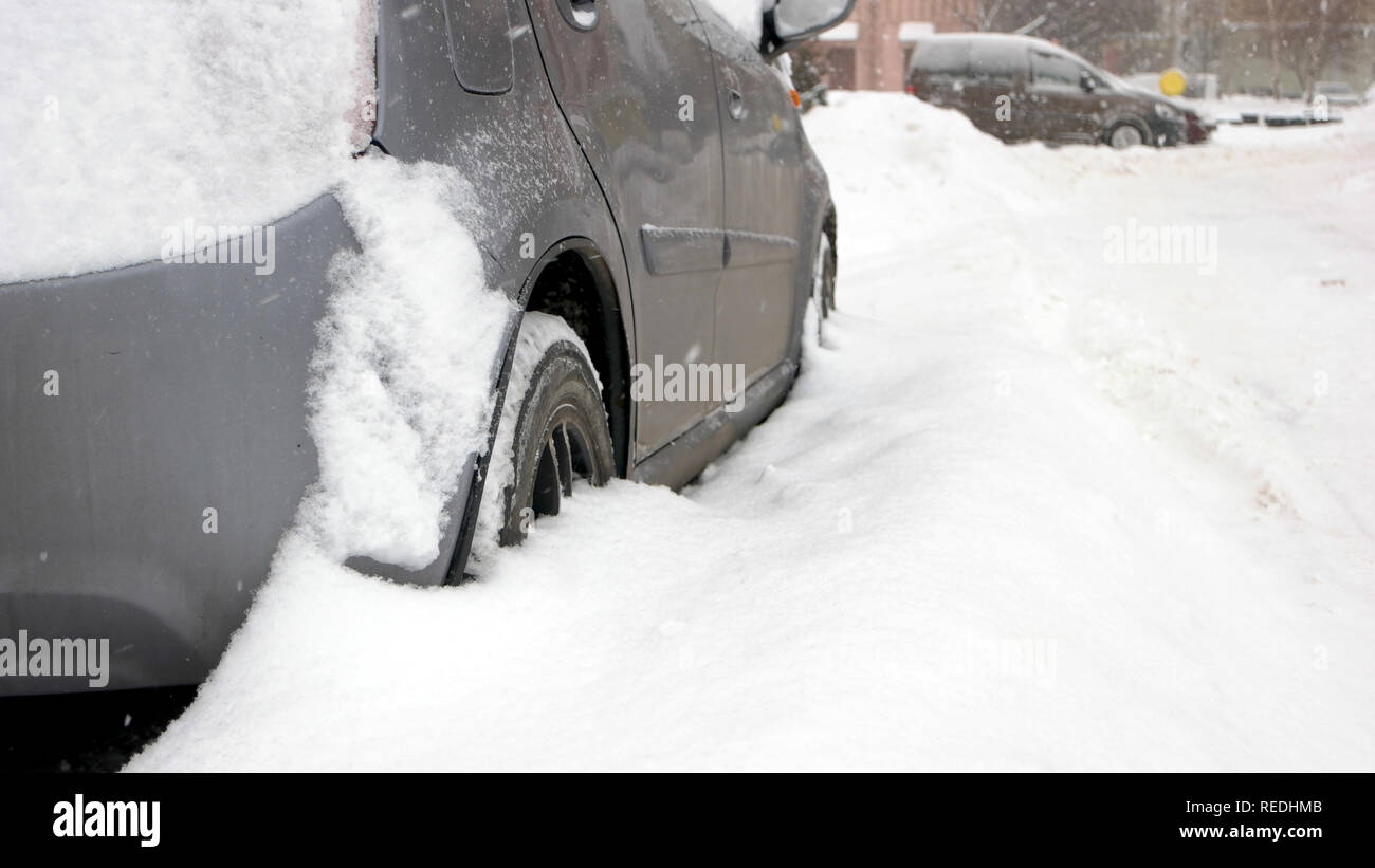 Passenger car stuck in snow, side view. Car blocked in the yard by ...