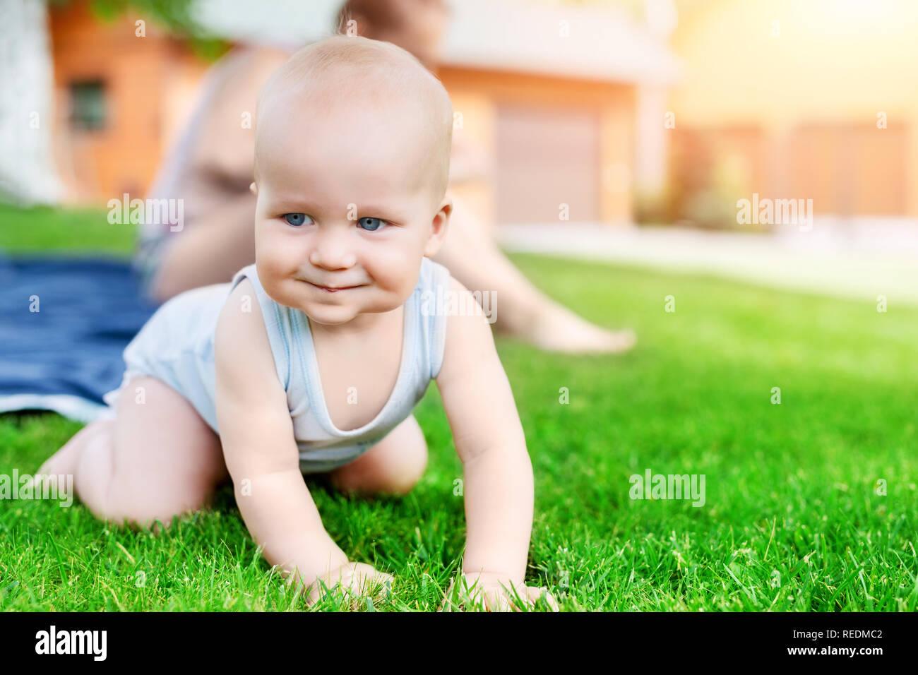Portrait of cute little caucasian boy having fun in garden with mother ...