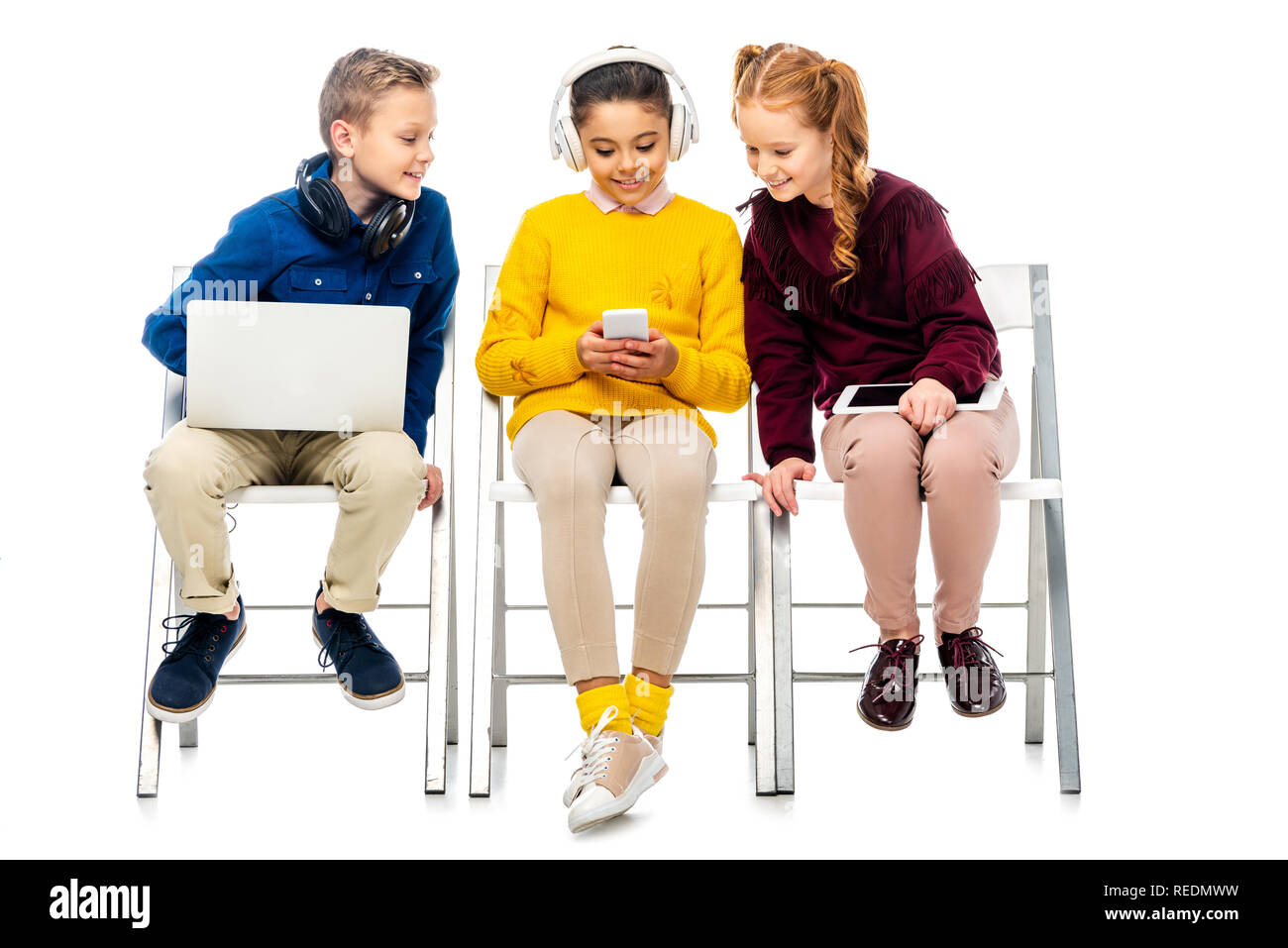 cute kids holding digital devices and looking at smartphone screen of ...
