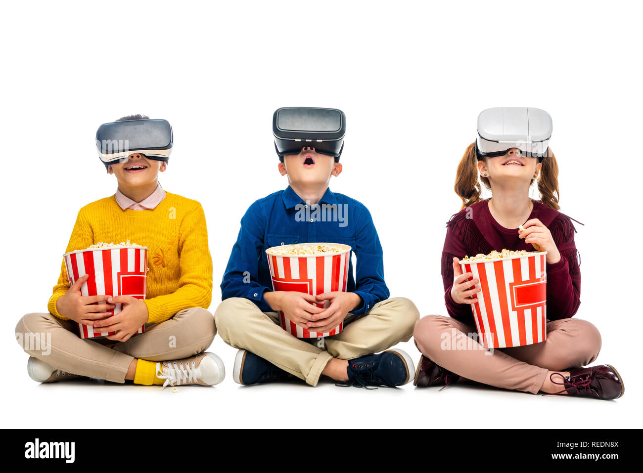 amazed children with virtual reality headsets on heads holding striped ...