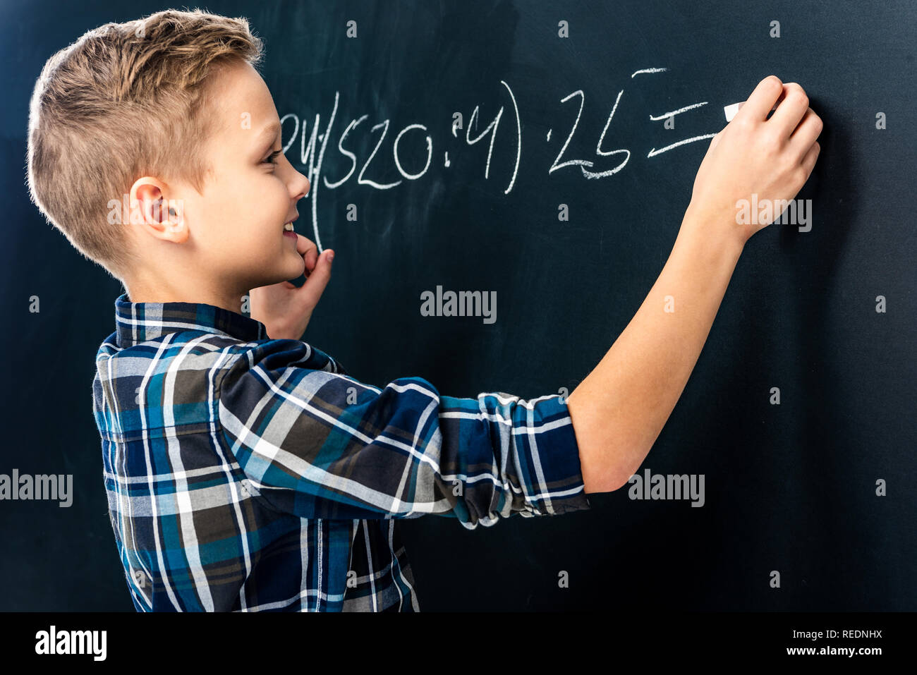 Pupil writing numbers on blackboard hi-res stock photography and images ...