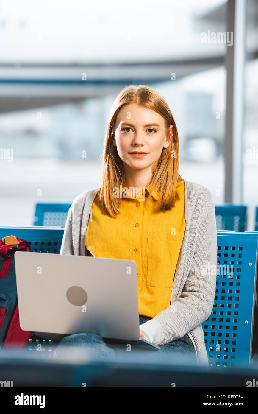 beautiful woman sitting with laptop in waiting hall Stock Photo - Alamy