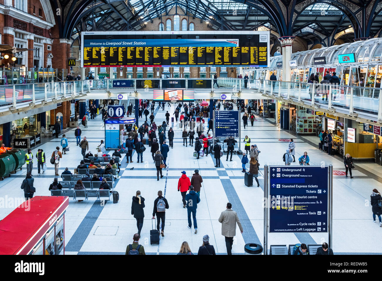 Passengers wait for trains and watch the station boards at London's ...
