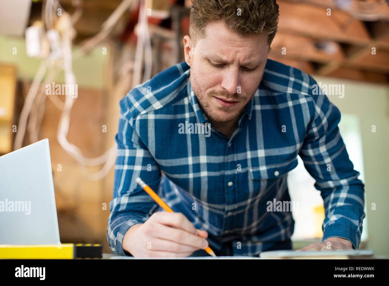 Architect Inside House Being Renovated Working On Plans Using Laptop ...