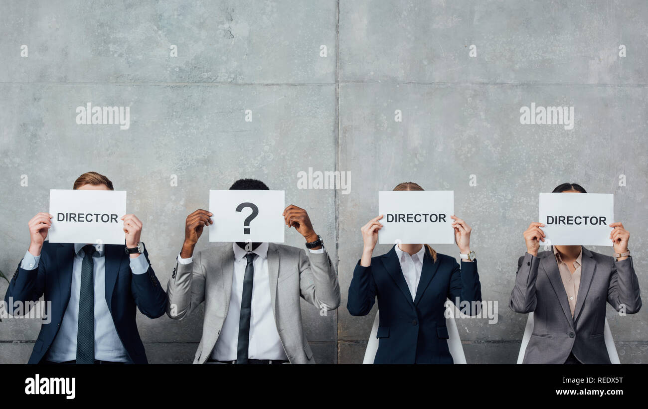 multiethnic businesspeople holding cards with 'director' words and ...
