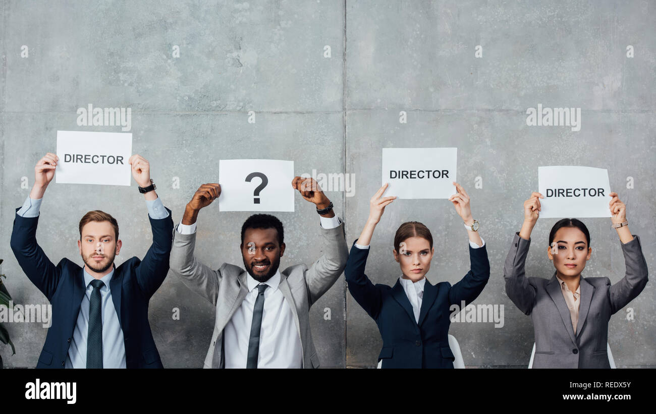 multiethnic businesspeople holding cards with 'director' words and ...