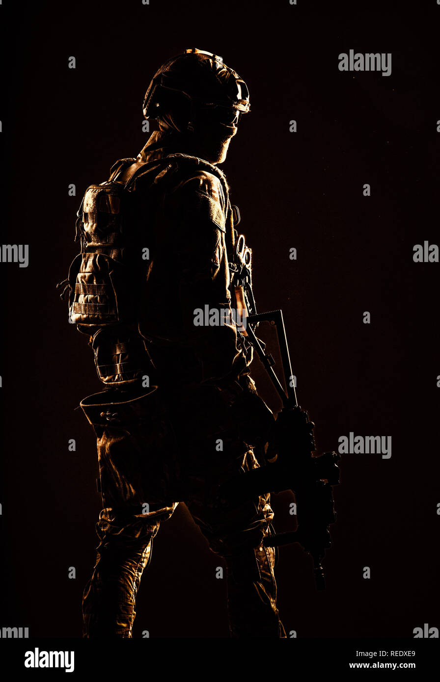 Low key studio shoot of army special forces soldier, commando fighter ...
