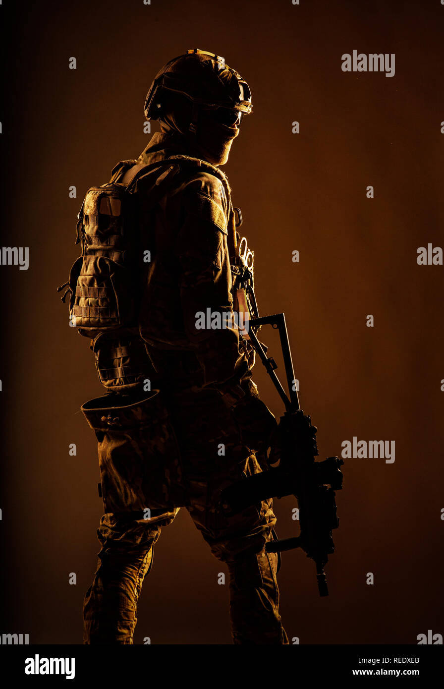 Low key studio shoot of army special forces soldier, commando fighter ...