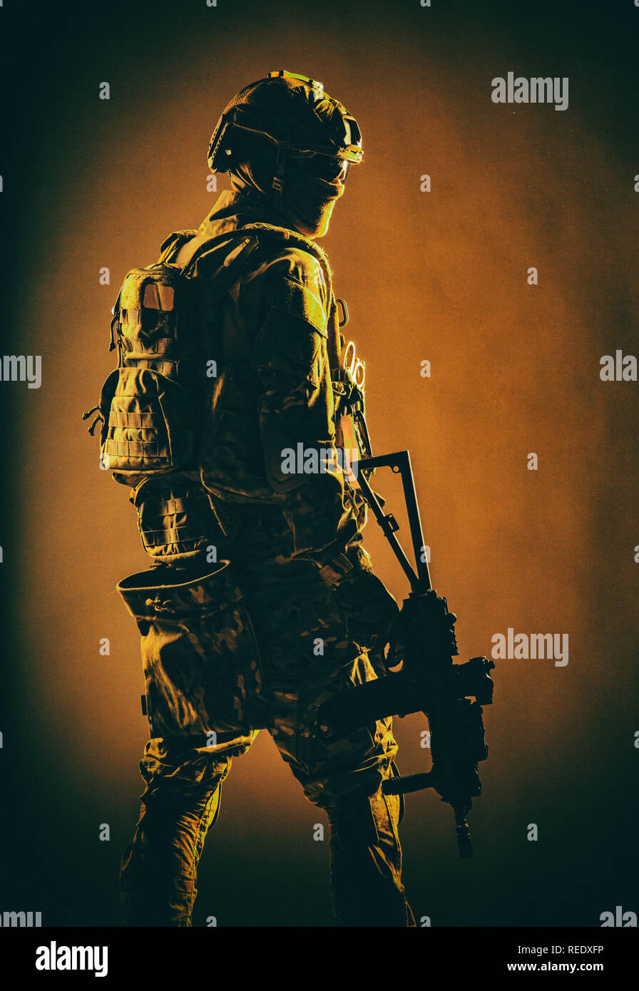 Low key studio shoot of army special forces soldier, commando fighter ...