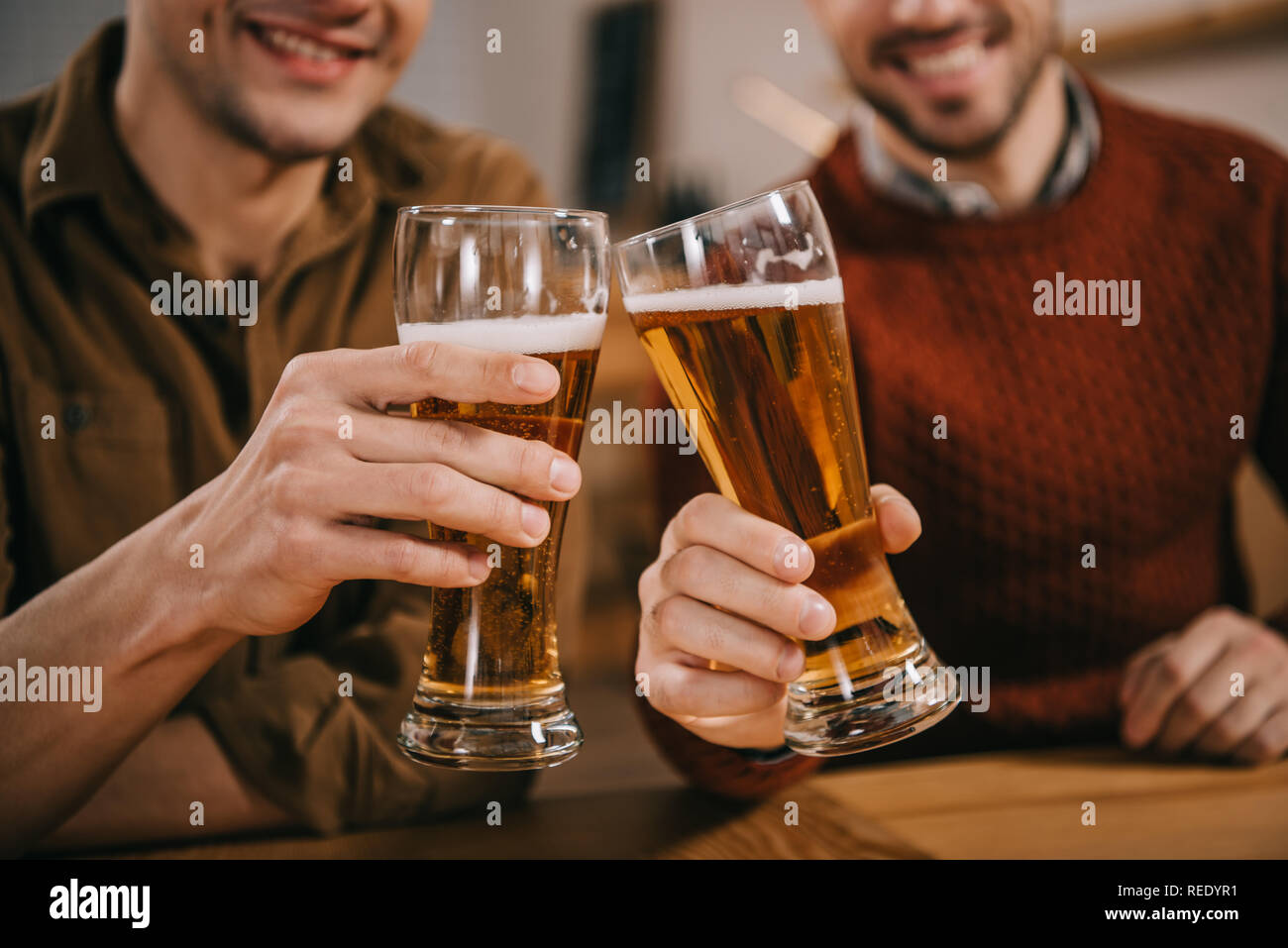 Hands holding clinking beer hi-res stock photography and images - Alamy
